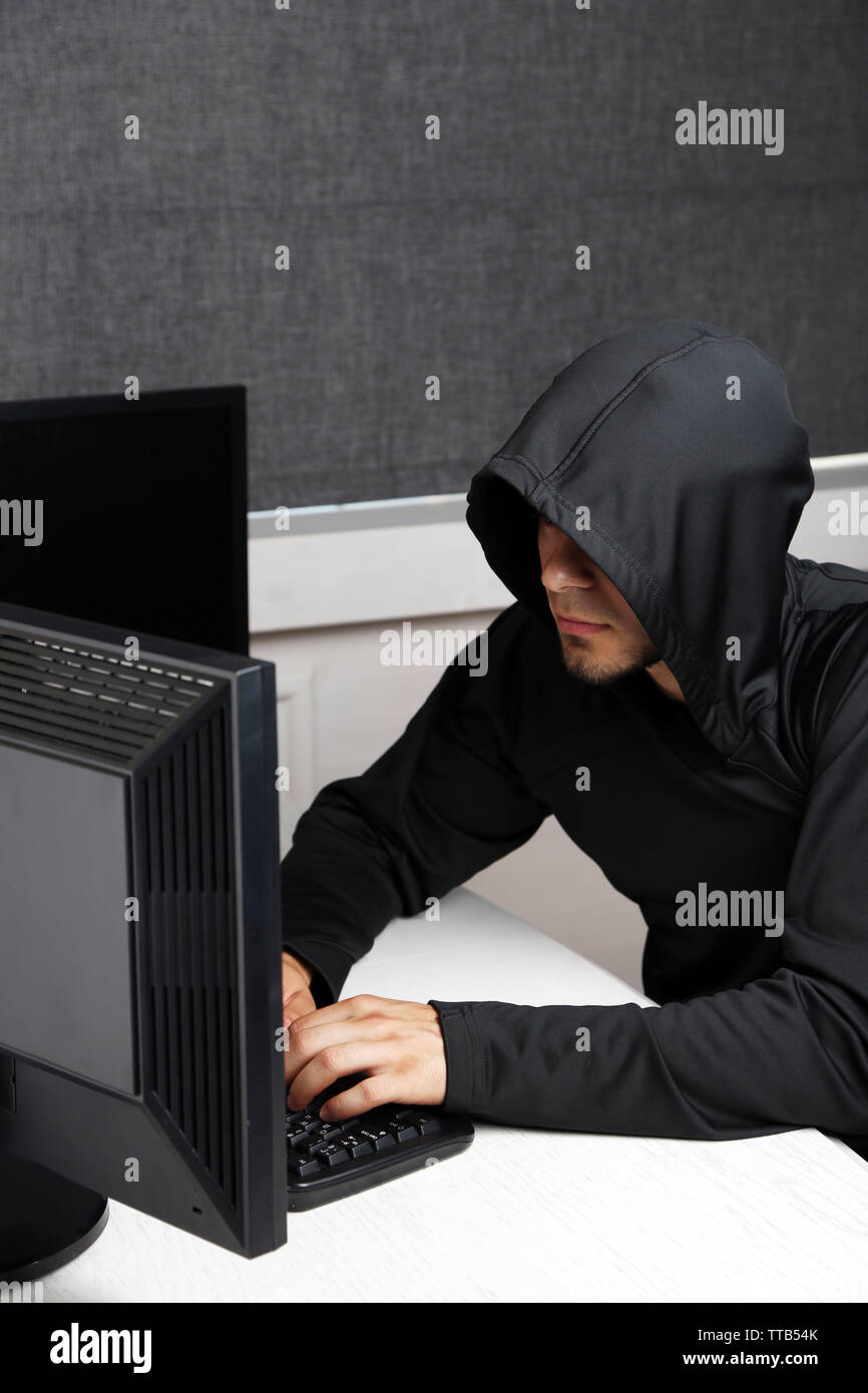 Hacker with computers in room Stock Photo - Alamy
