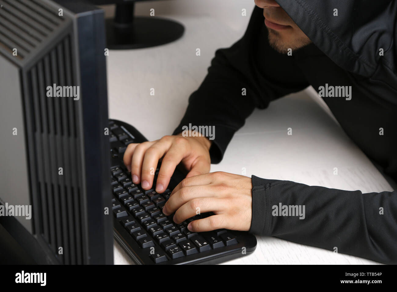 Hacker with computers in room Stock Photo - Alamy
