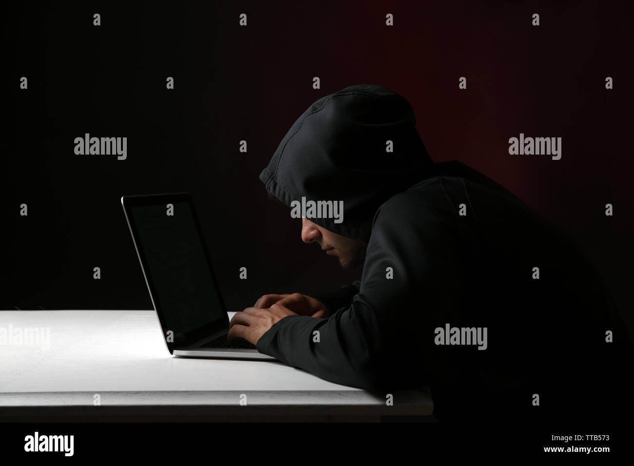 Hacker with computer and laptop on colorful dark background Stock Photo ...