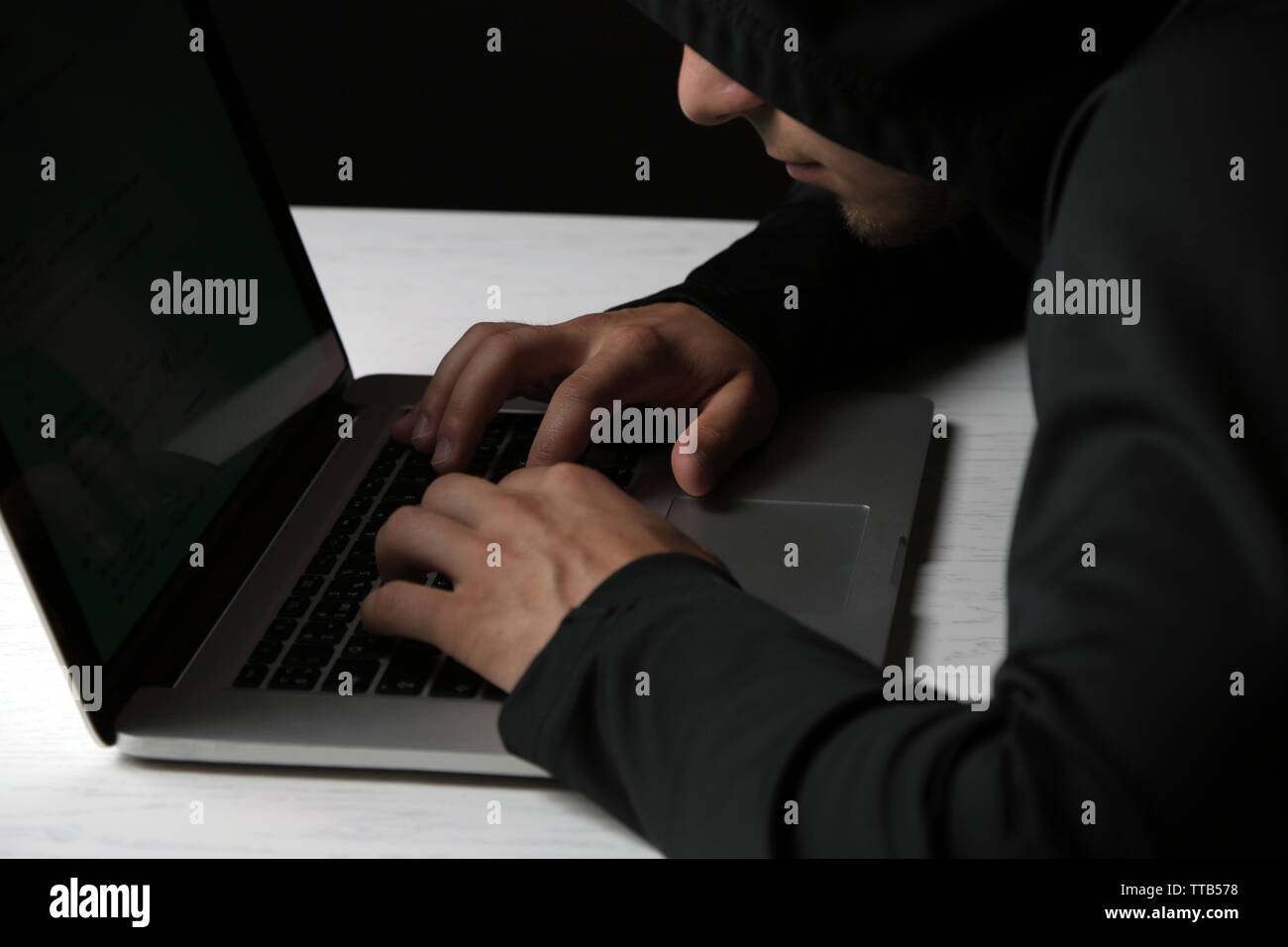 Hacker with computer and laptop on colorful dark background Stock Photo ...