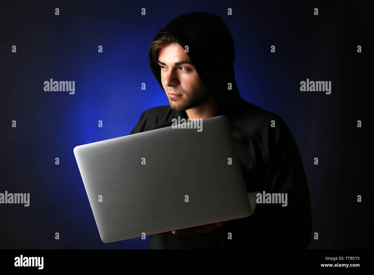 Hacker with computer and laptop on colorful dark background Stock Photo ...