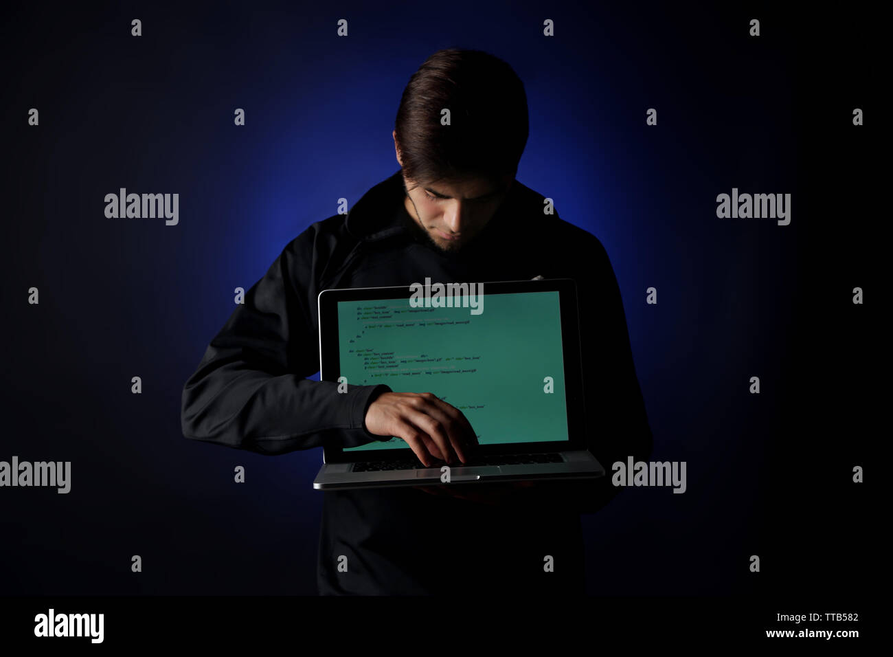 Hacker with computer and laptop on colorful dark background Stock Photo ...