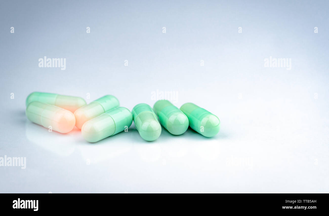 Selective focus on green capsule pill of herbal medicine ...