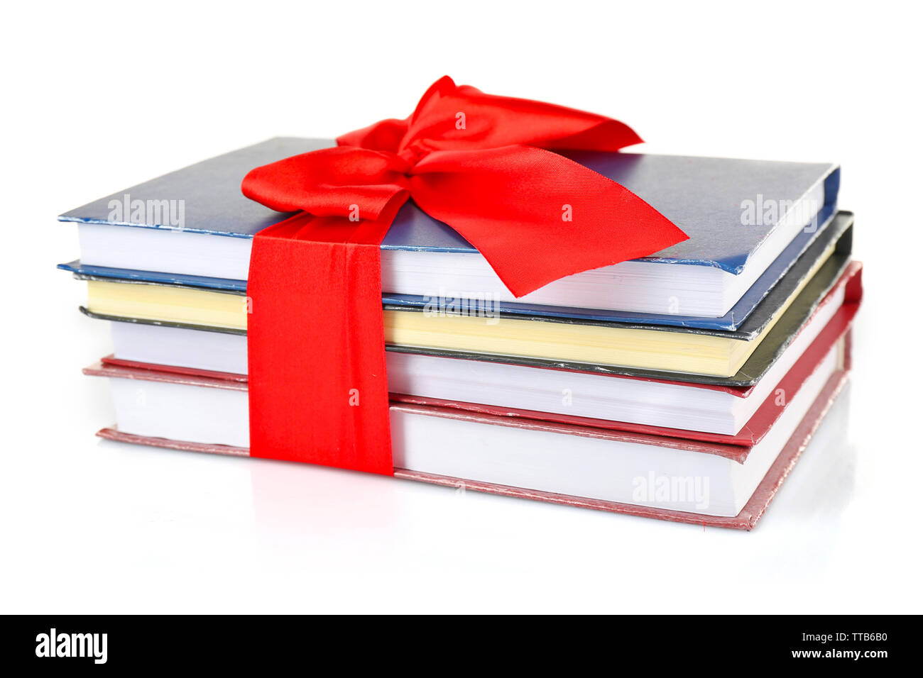 Stack of books with ribbon isolated on white Stock Photo - Alamy