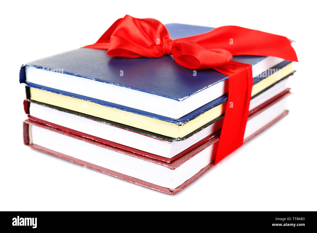 Stack of books with ribbon isolated on white Stock Photo - Alamy