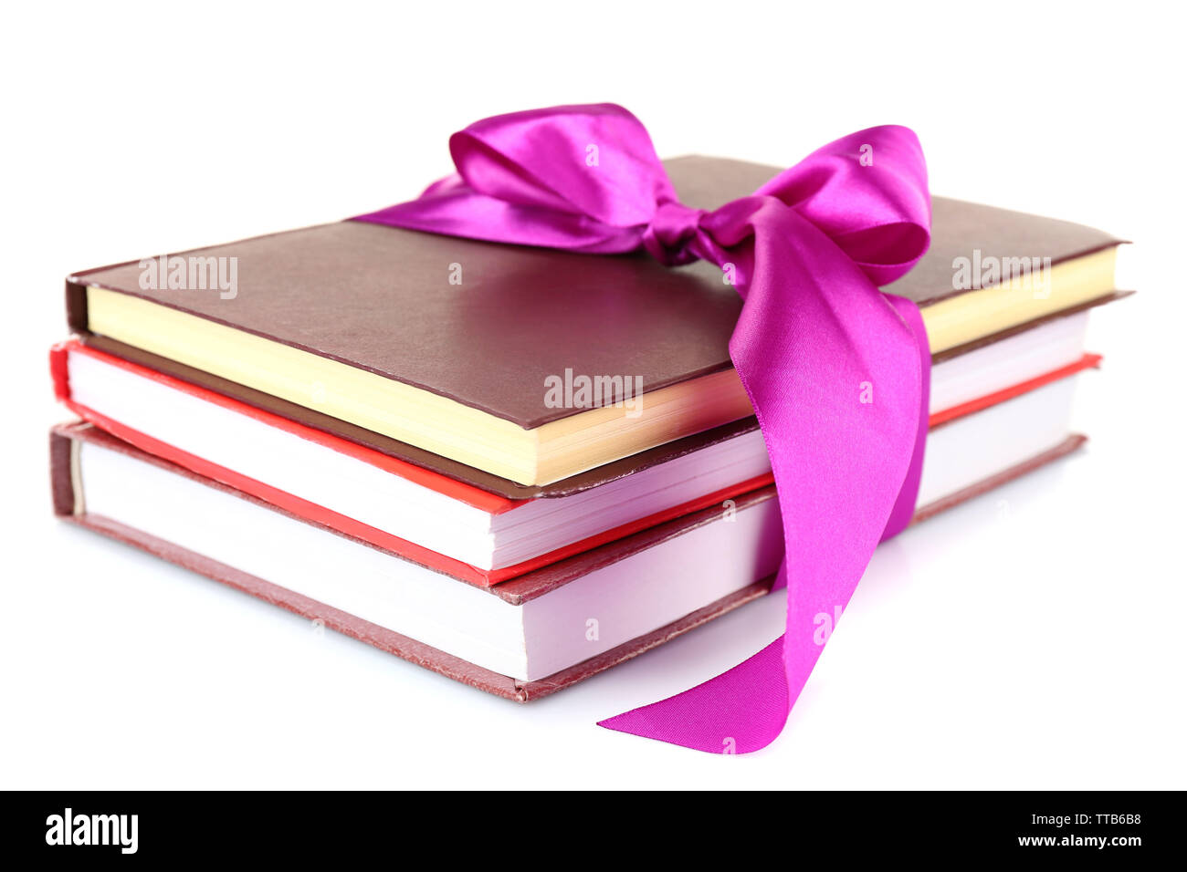 Stack of books with ribbon isolated on white Stock Photo - Alamy