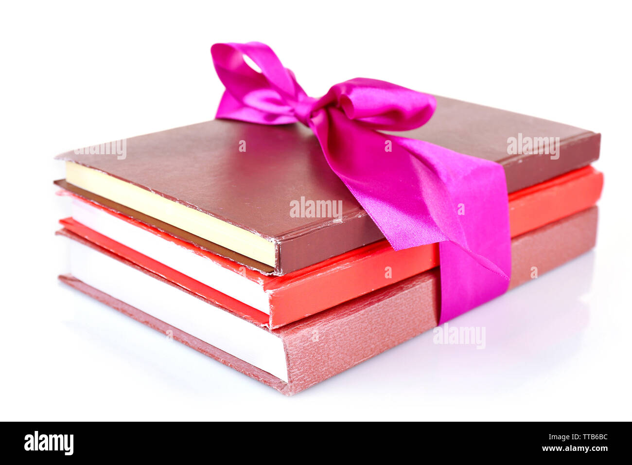Stack of books with ribbon isolated on white Stock Photo - Alamy