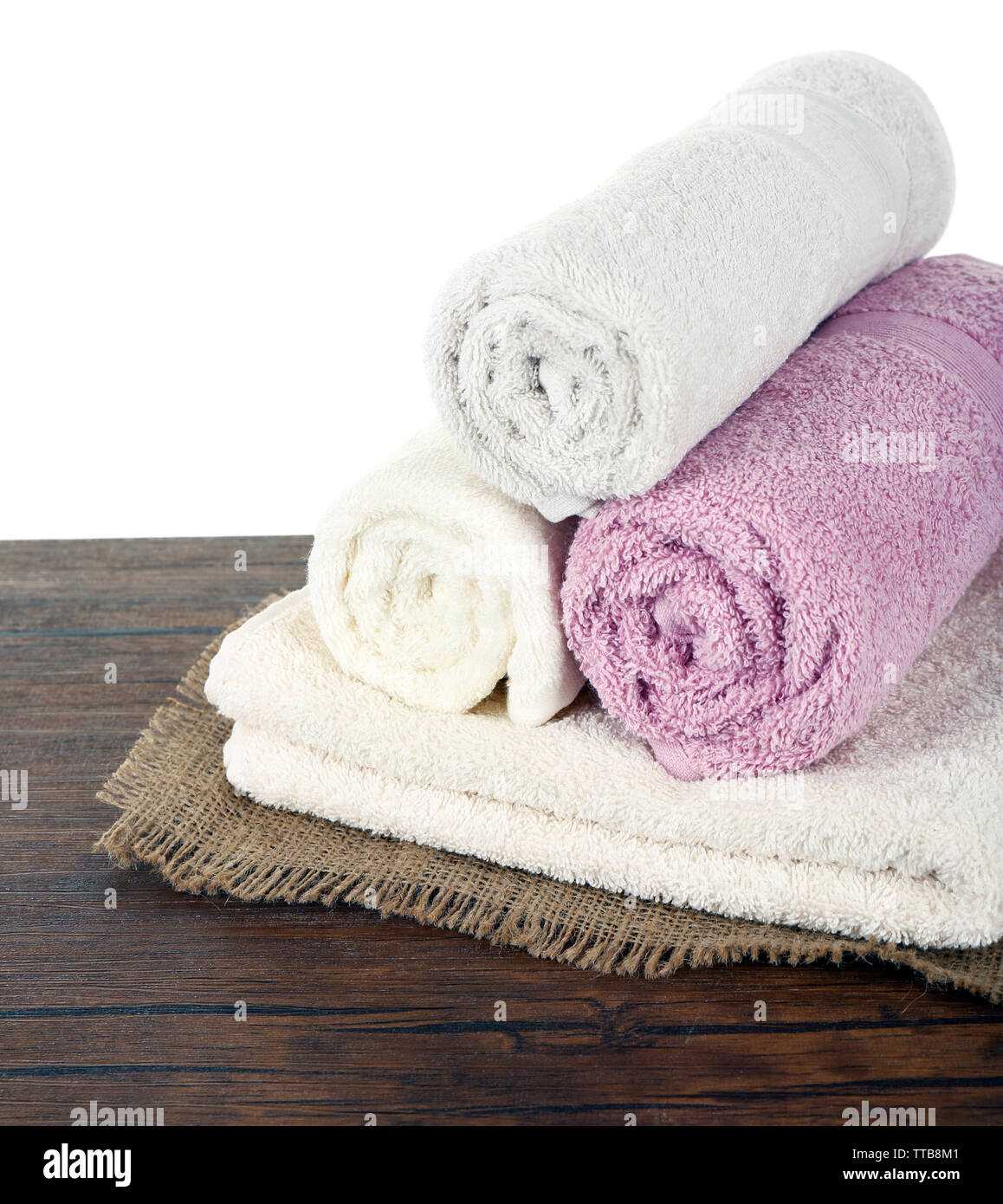 Soft towels on table isolated on white Stock Photo - Alamy