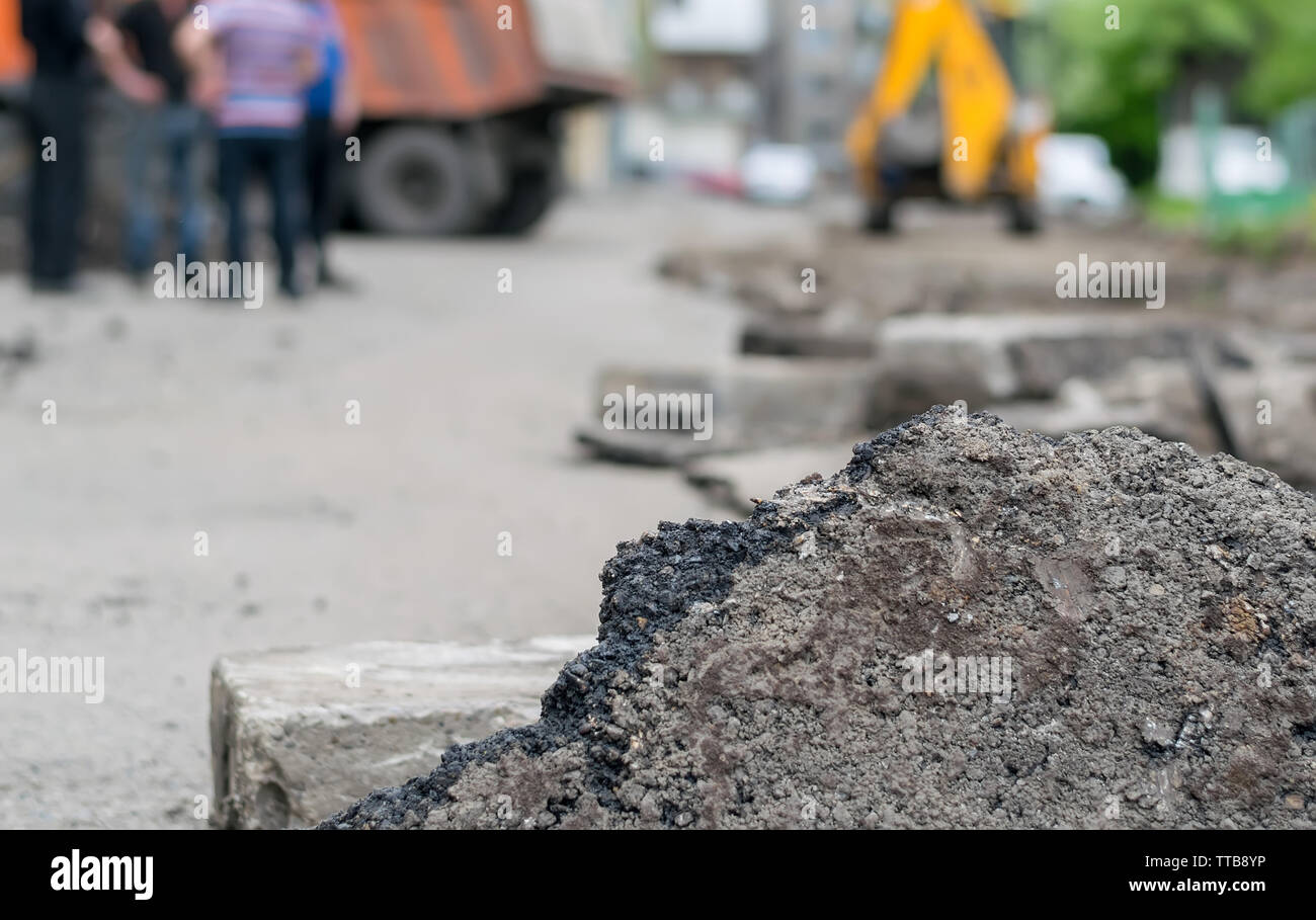a piece of asphalt on the destroyed road yard of a house on the ...