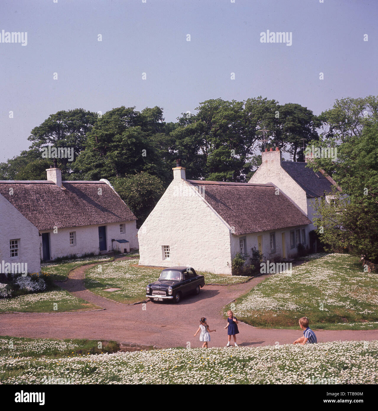 1960s, historical, children playing outside traditional white-washed ...