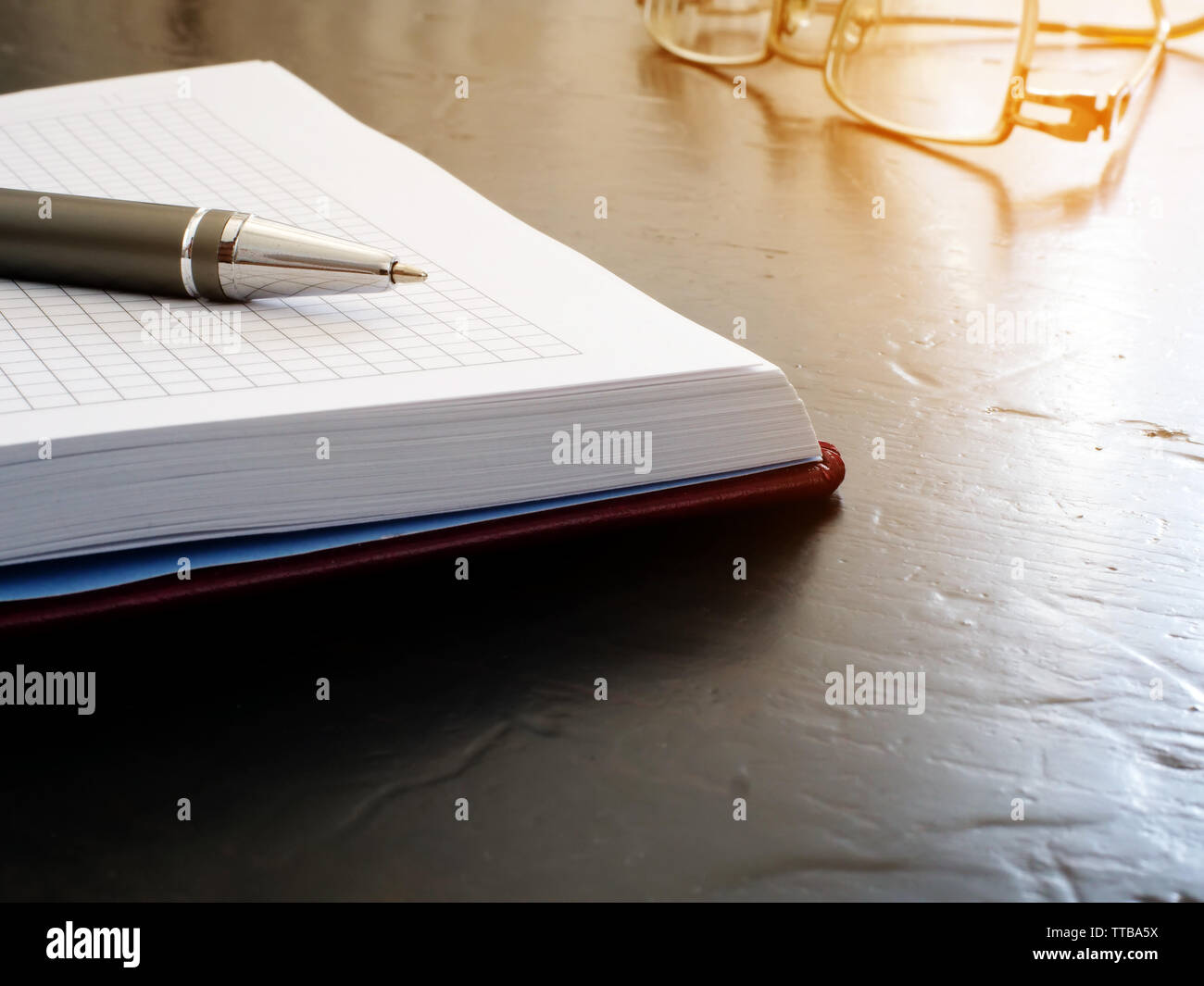 Open note pad with pen and glasses. Reminder on the desk Stock Photo ...