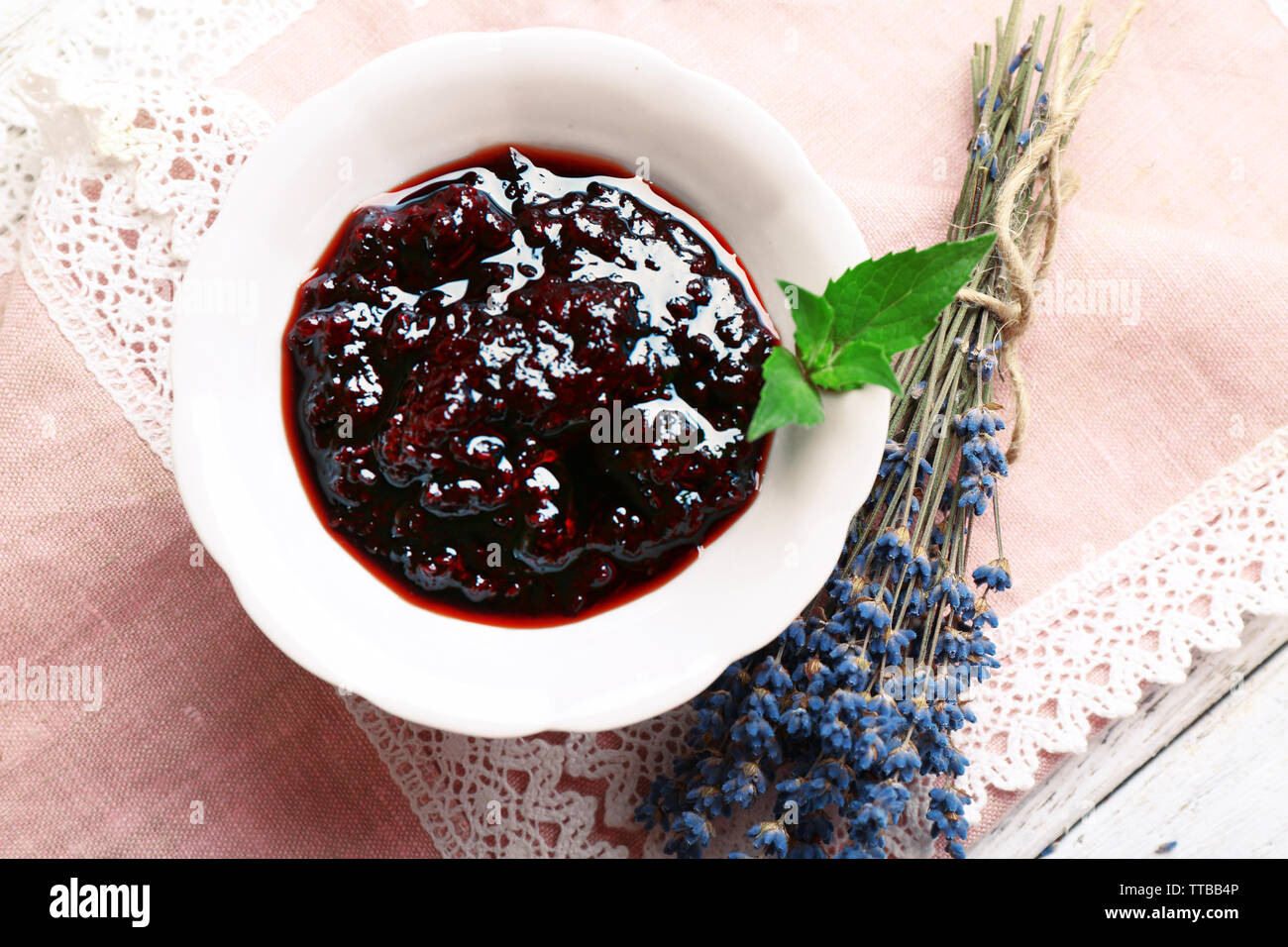 Tasty currant jam with berries on table close up Stock Photo - Alamy
