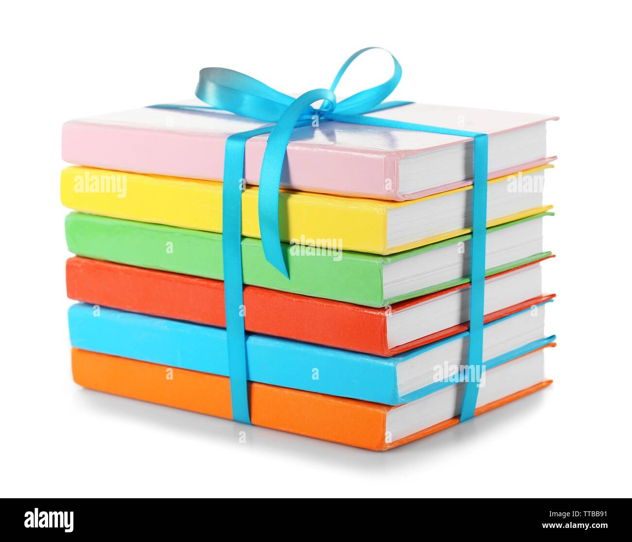 Stack of books with ribbon isolated on white Stock Photo - Alamy