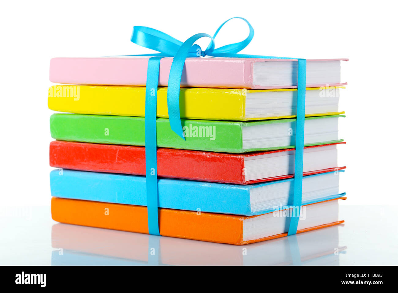 Stack of books with ribbon isolated on white Stock Photo - Alamy