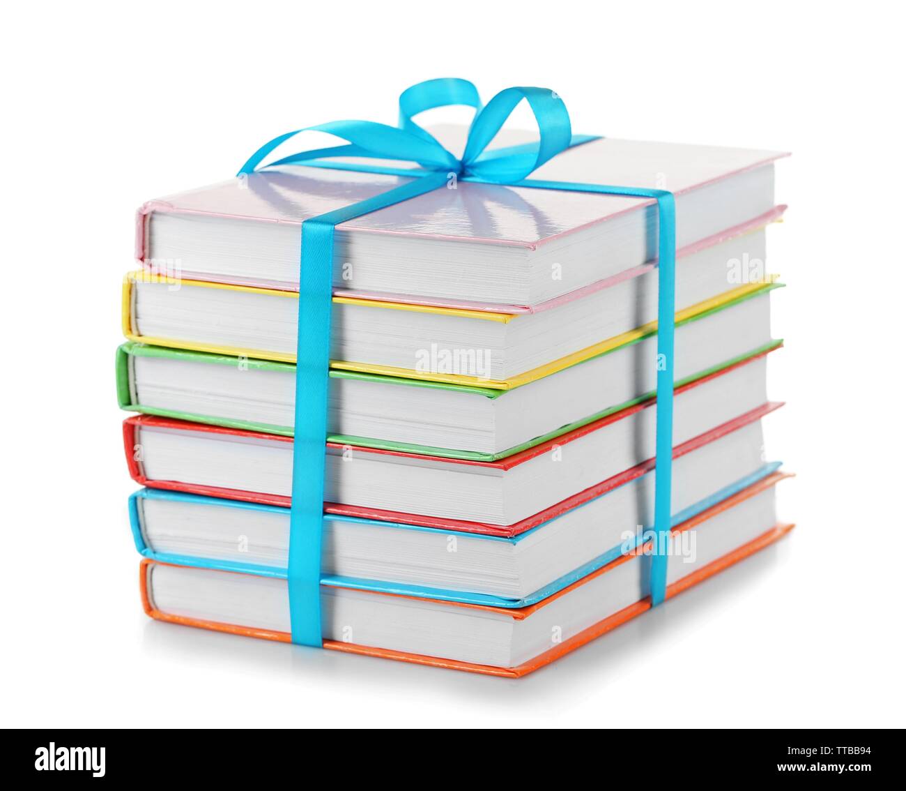 Stack of books with ribbon isolated on white Stock Photo - Alamy