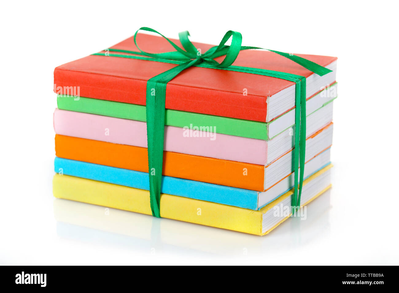 Stack of books with ribbon isolated on white Stock Photo - Alamy