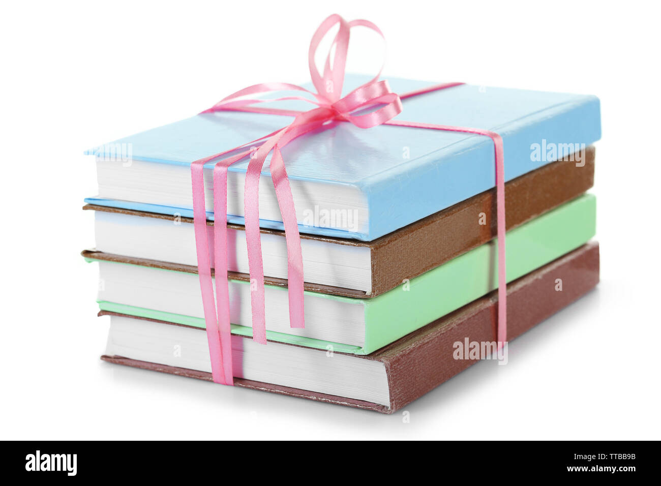 Stack of books with ribbon isolated on white Stock Photo - Alamy