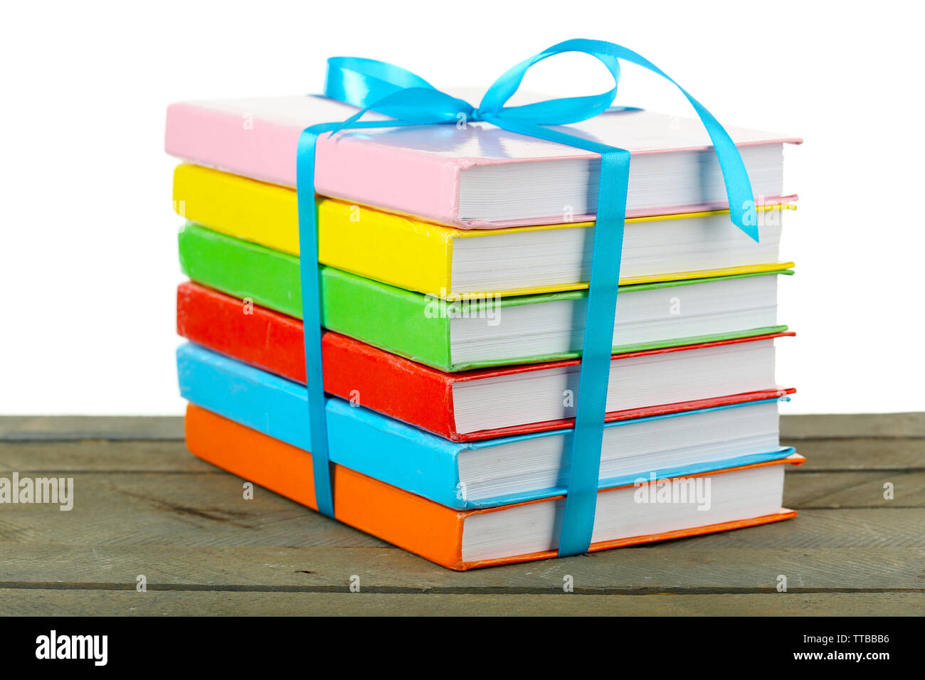 Stack of books with ribbon on light background Stock Photo - Alamy