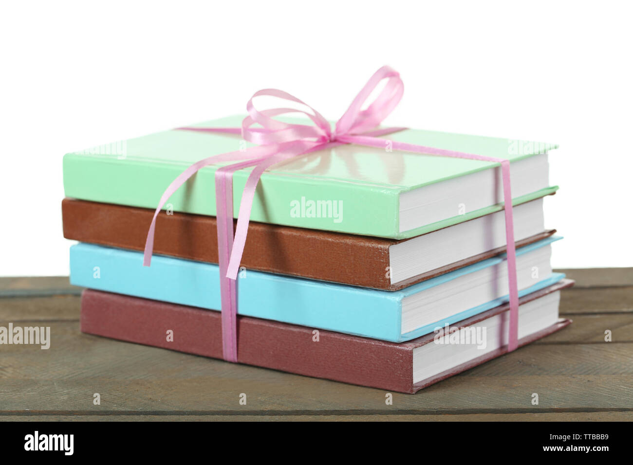 Stack of books with ribbon on light background Stock Photo - Alamy