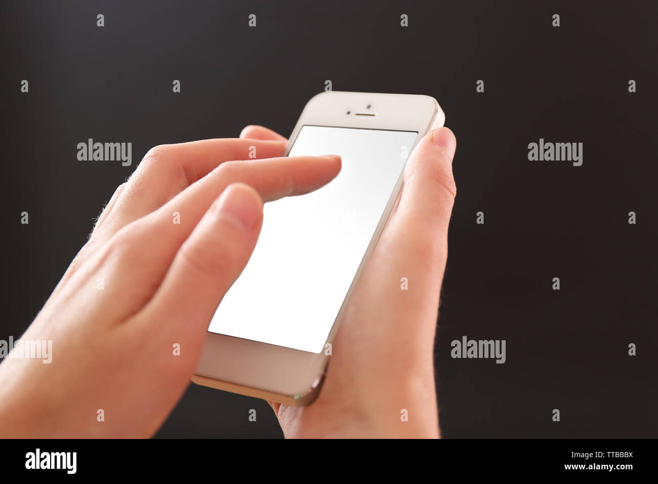 Finger touch number on smartphone to make a call on black background ...