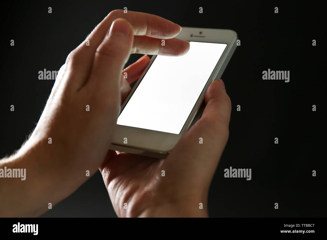 Finger touch number on smartphone to make a call on black background ...