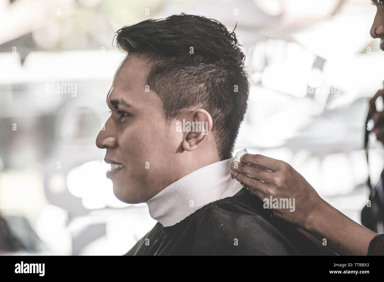 side view portrait of attractive asian man having his neck covering by ...