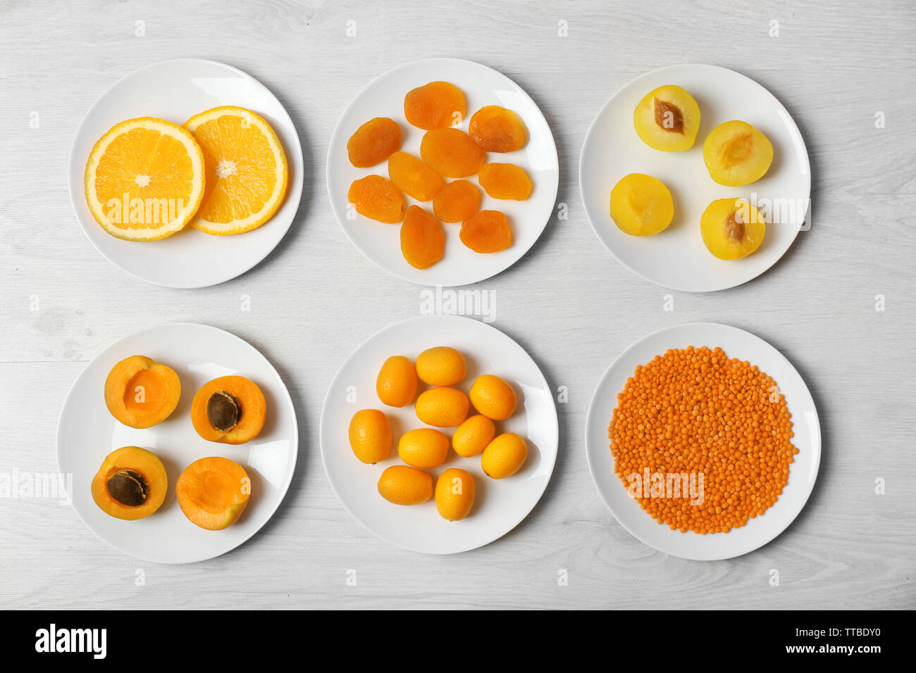 Set of orange products on wooden background Stock Photo - Alamy