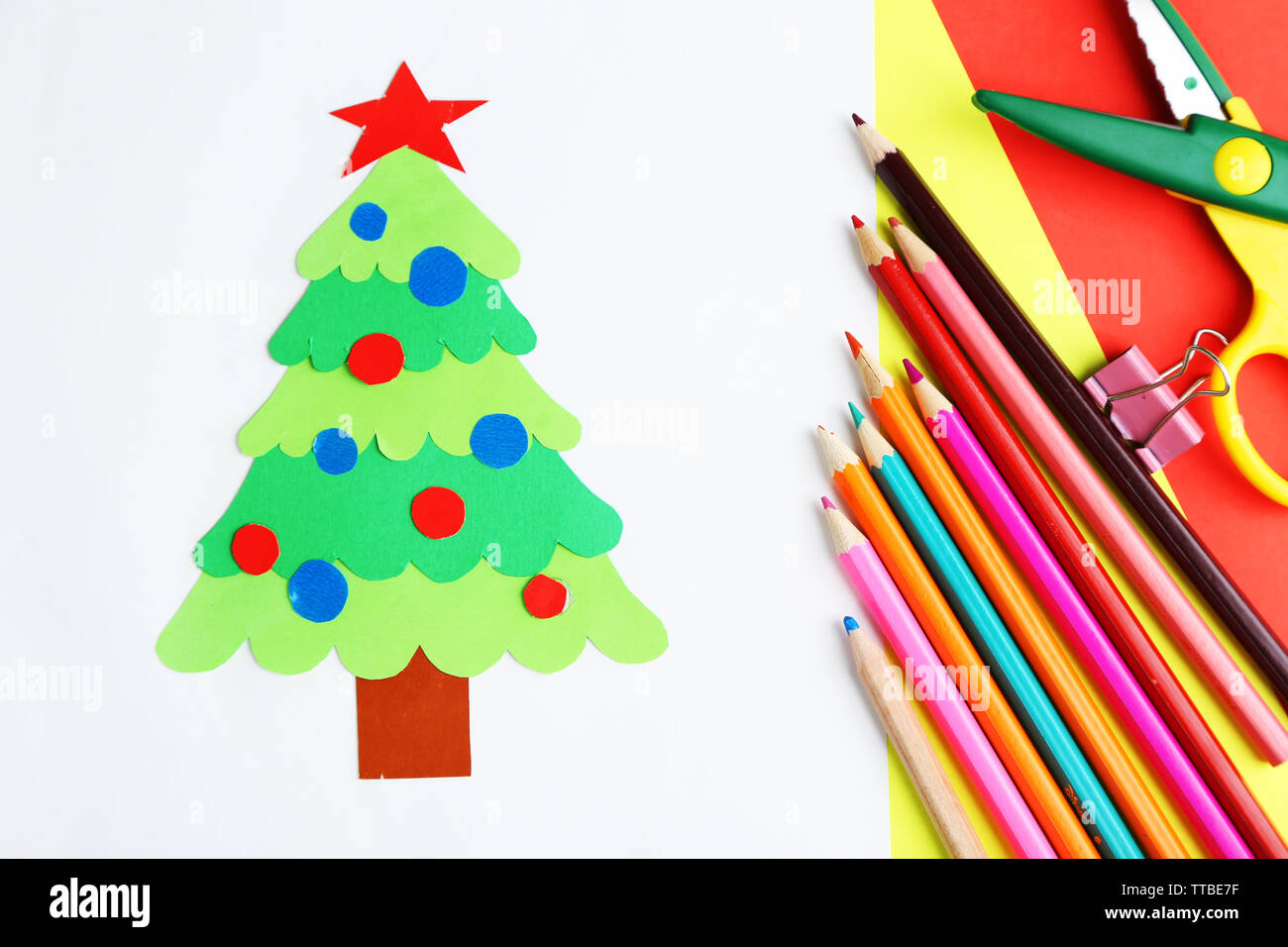 Creative paper Christmas tree on white paper sheet, scissors and ...