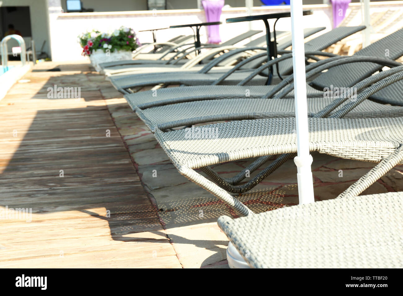 Sunbeds near swimming pool, outdoor Stock Photo - Alamy