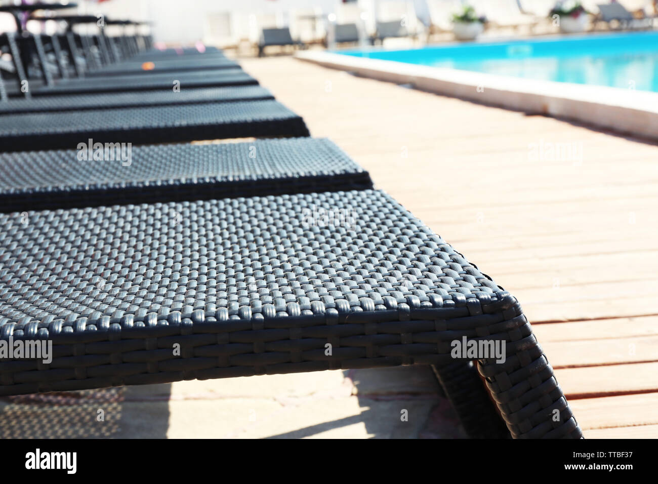 Sunbeds near swimming pool, outdoor Stock Photo - Alamy