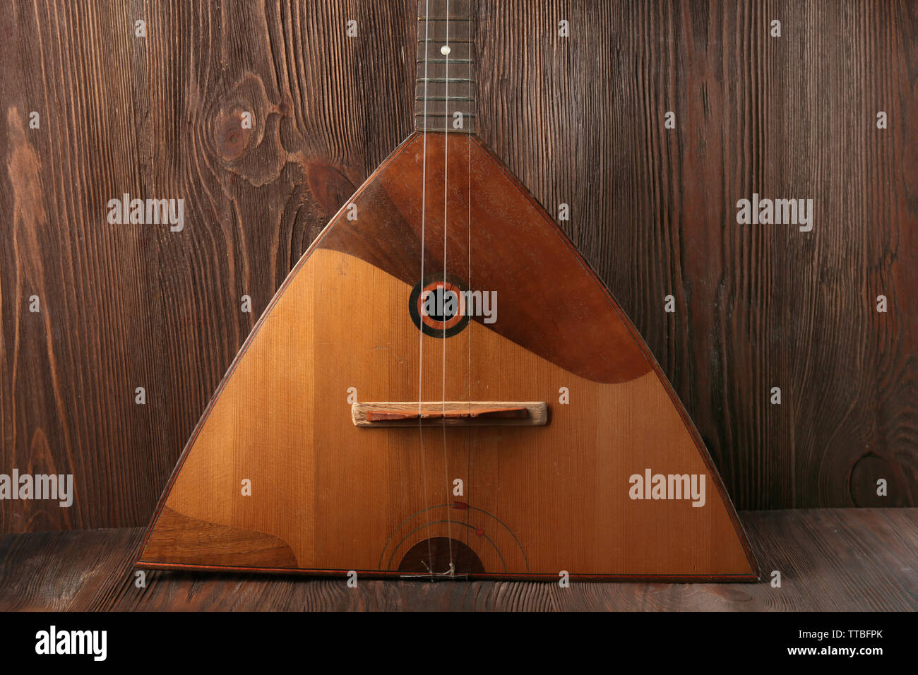 Folk musical instrument balalaika on wooden background Stock Photo - Alamy