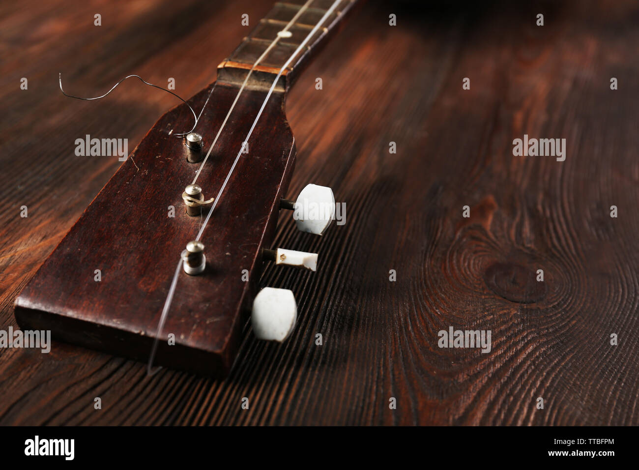 Folk musical instrument balalaika on wooden background Stock Photo - Alamy