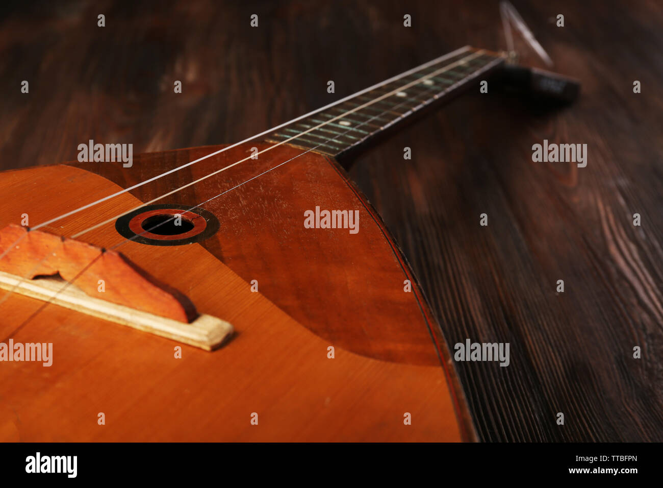 Folk musical instrument balalaika on wooden background Stock Photo - Alamy