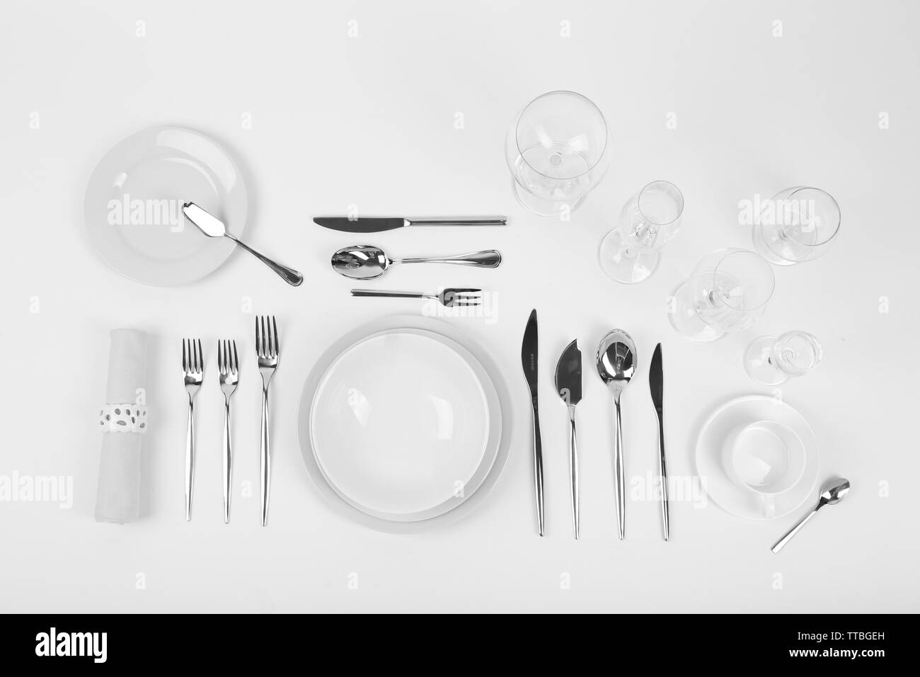 Table setting, close up, on white background Stock Photo - Alamy