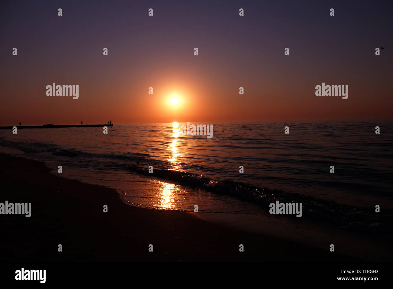 View of beautiful sunrise on the beach Stock Photo - Alamy
