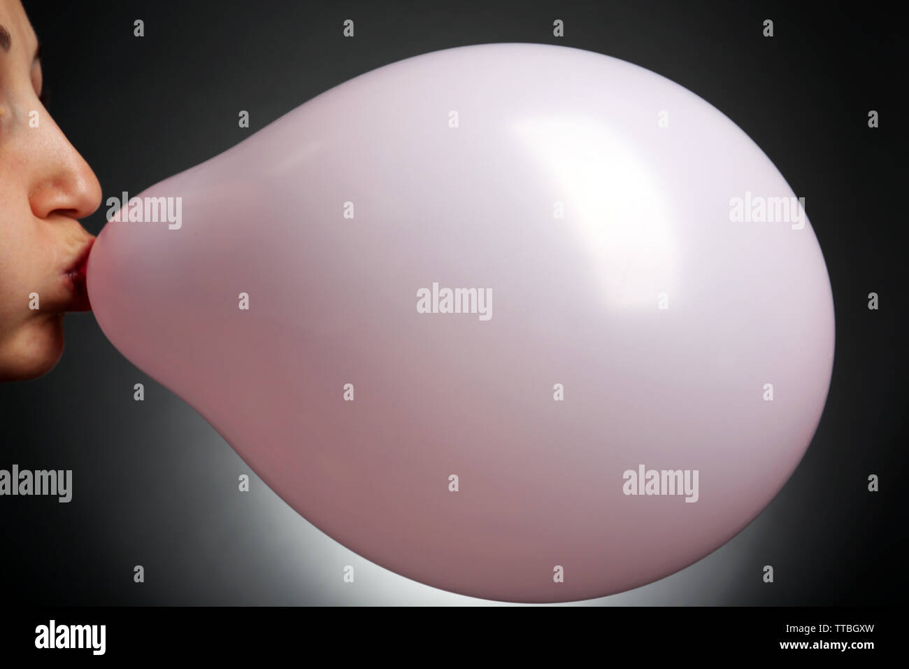 Woman inflating balloon hi-res stock photography and images - Alamy