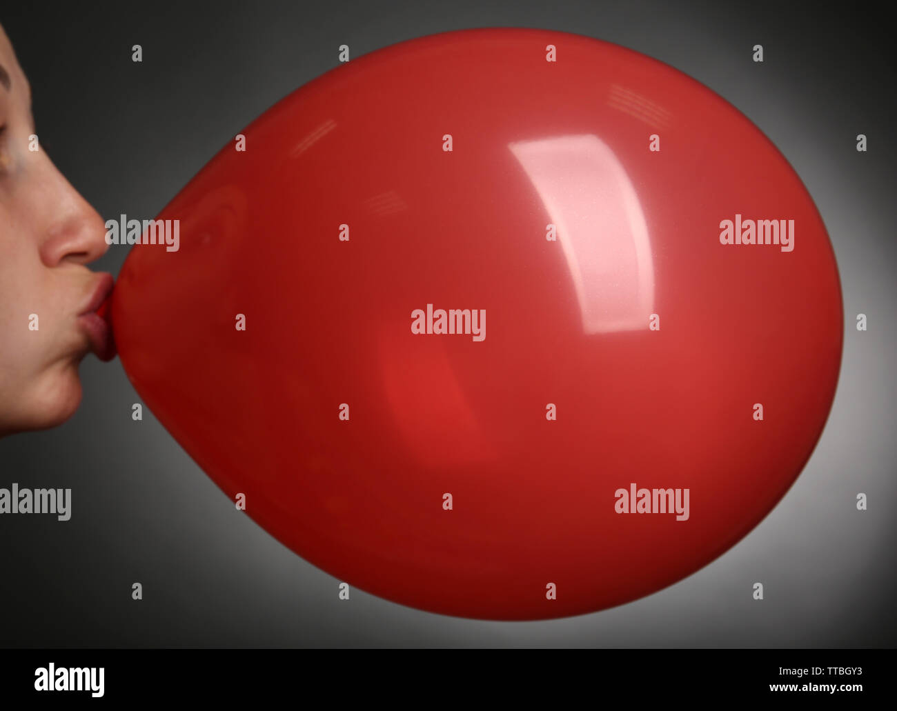 Woman inflating balloon hi-res stock photography and images - Alamy