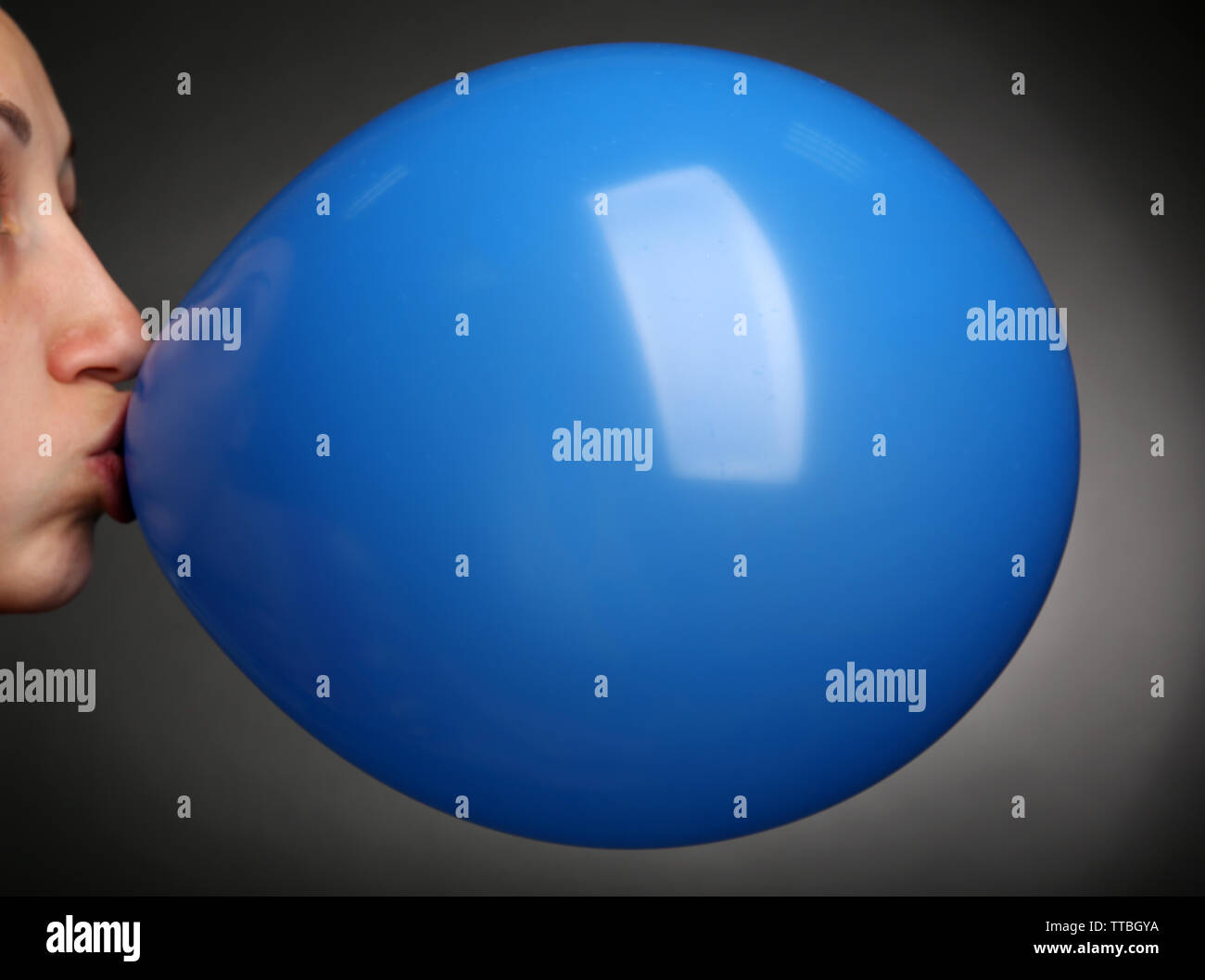 Woman inflating balloon hi-res stock photography and images - Alamy