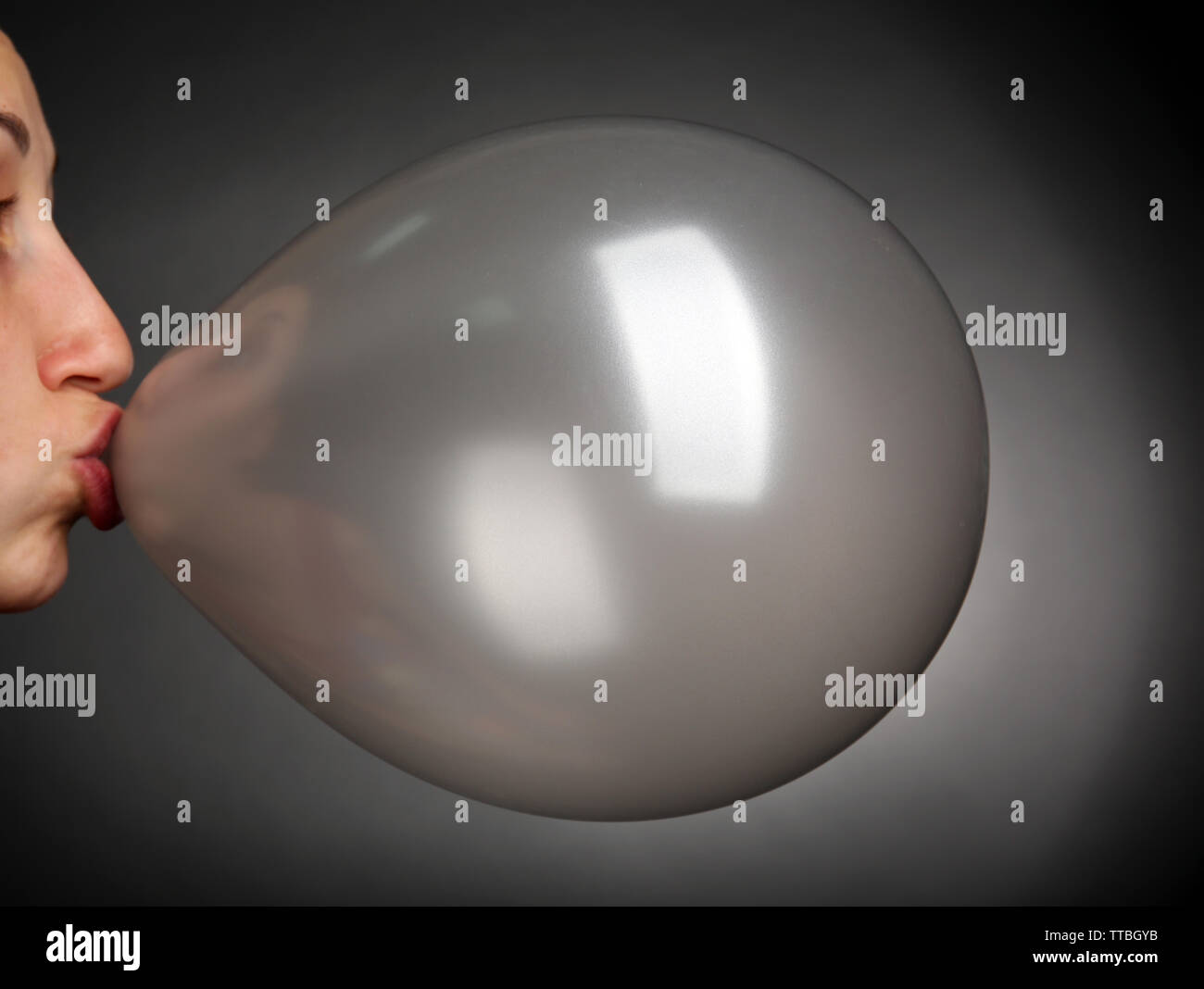 Woman Inflating Balloon High Resolution Stock Photography and Images ...