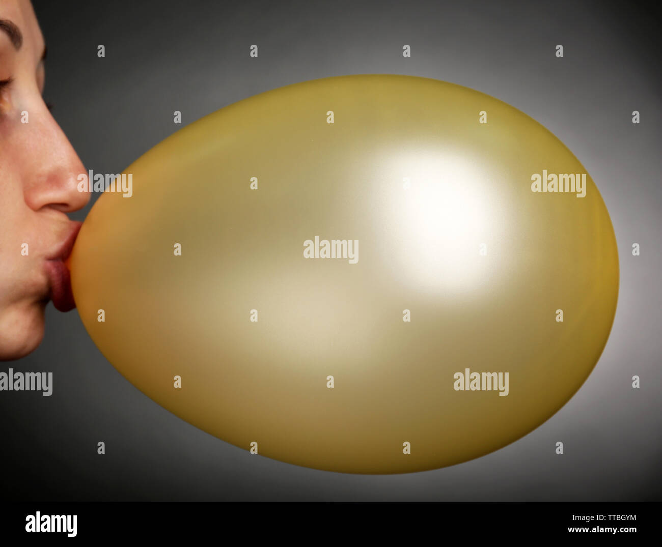 Woman inflating balloon hi-res stock photography and images - Alamy