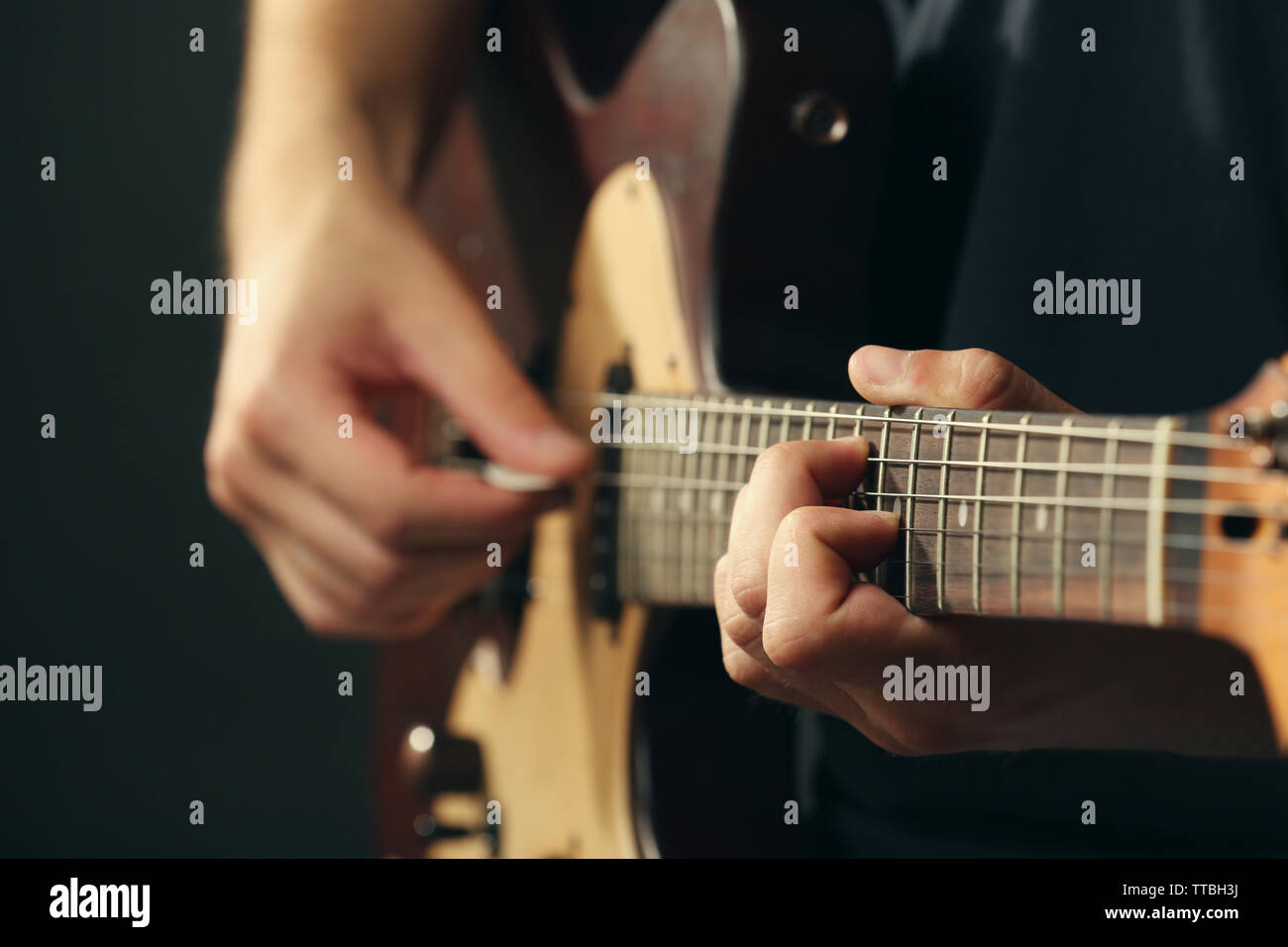 Young musician playing acoustic guitar close up Stock Photo - Alamy