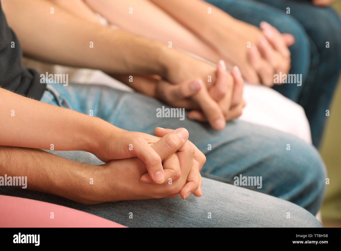 Young people holding hands close up Stock Photo - Alamy