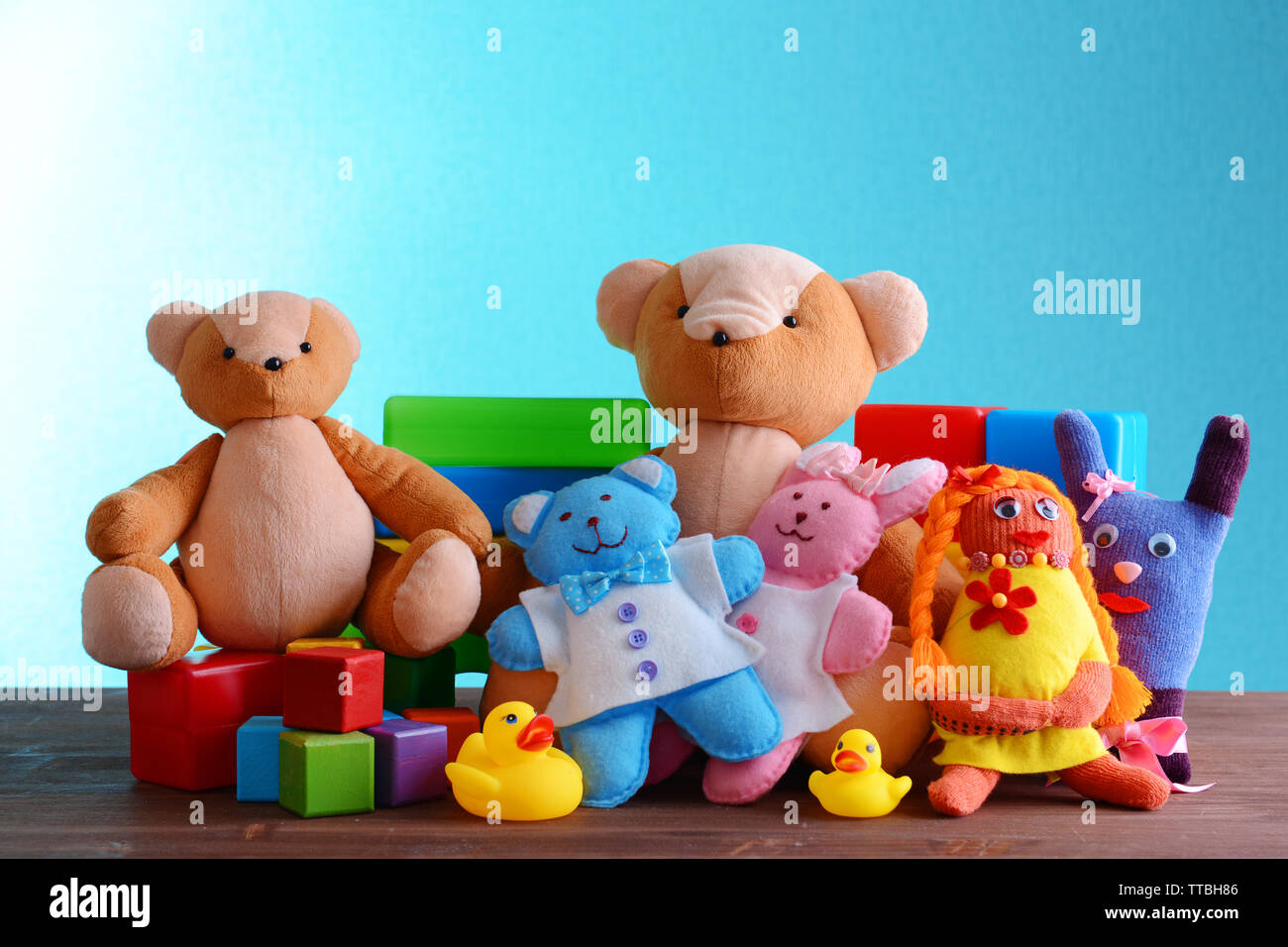 Pile of toys on blue background Stock Photo - Alamy