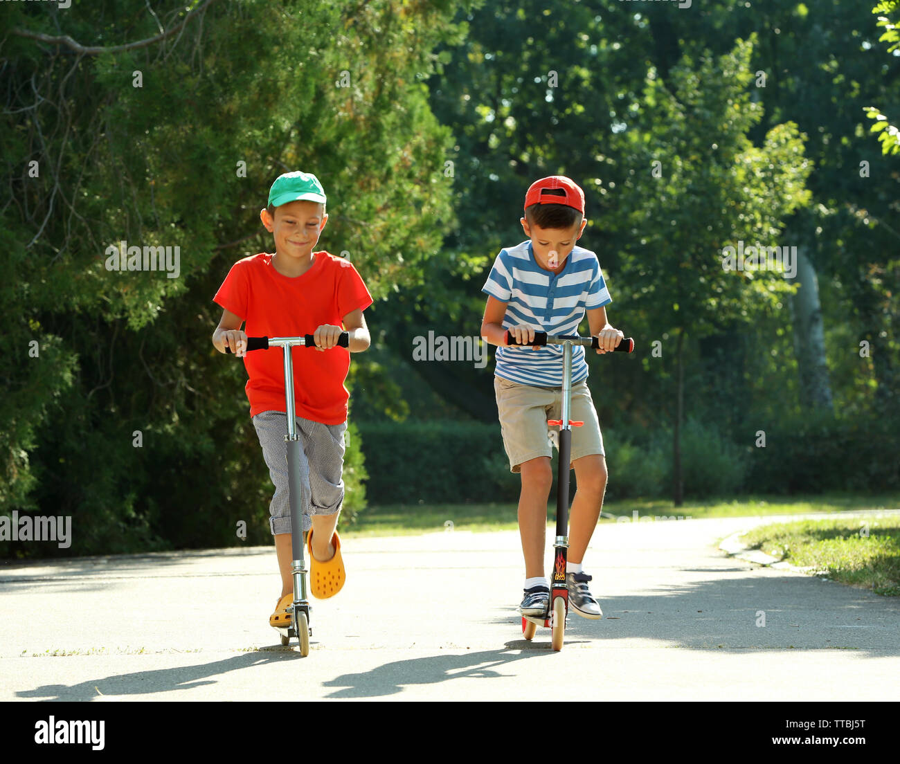 Boys on scooters hi-res stock photography and images - Alamy