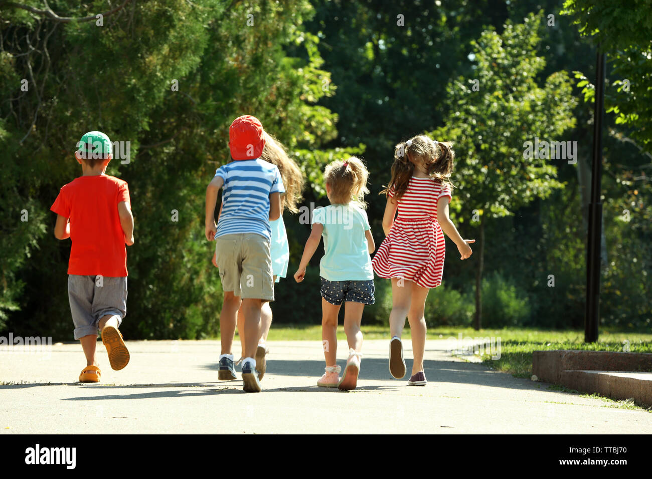 Happy active children running in park Stock Photo - Alamy