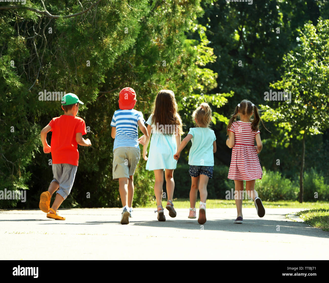 Happy active children running in park Stock Photo - Alamy