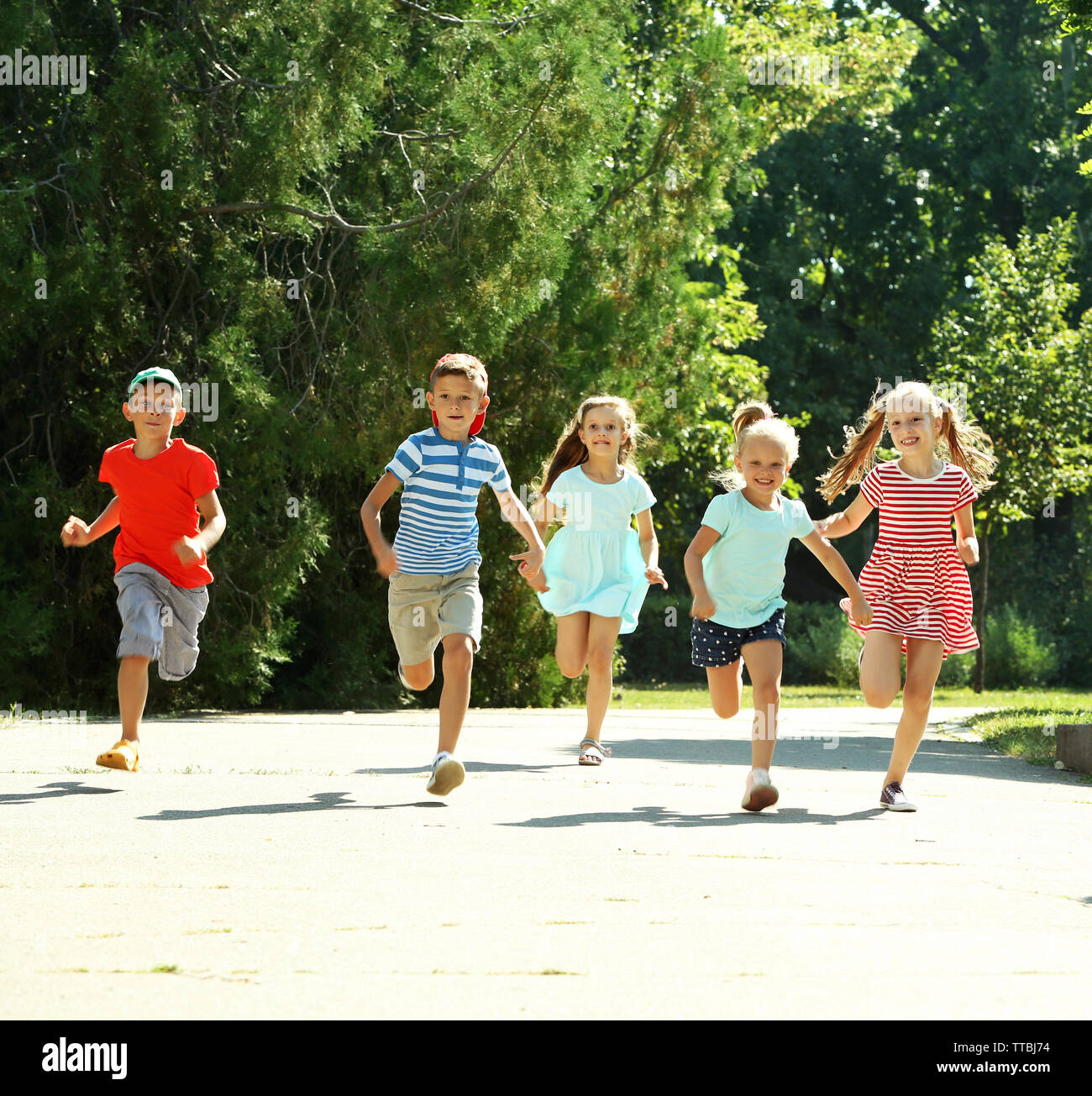 Happy active children running in park Stock Photo - Alamy