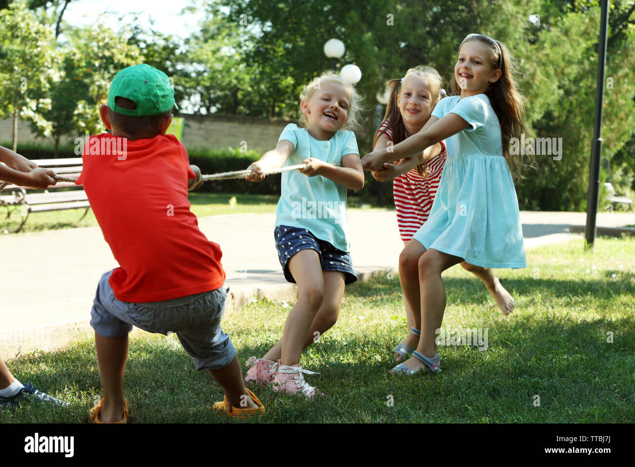 Happy active children playing in park Stock Photo - Alamy