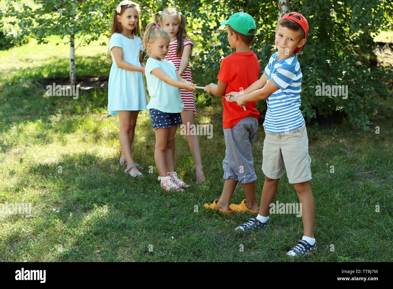 Happy active children playing in park Stock Photo - Alamy