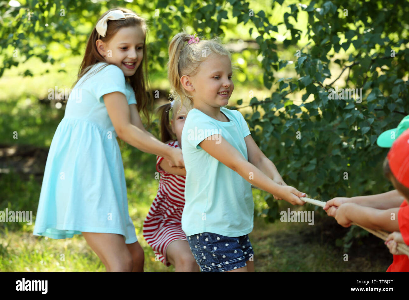Happy active children playing in park Stock Photo - Alamy